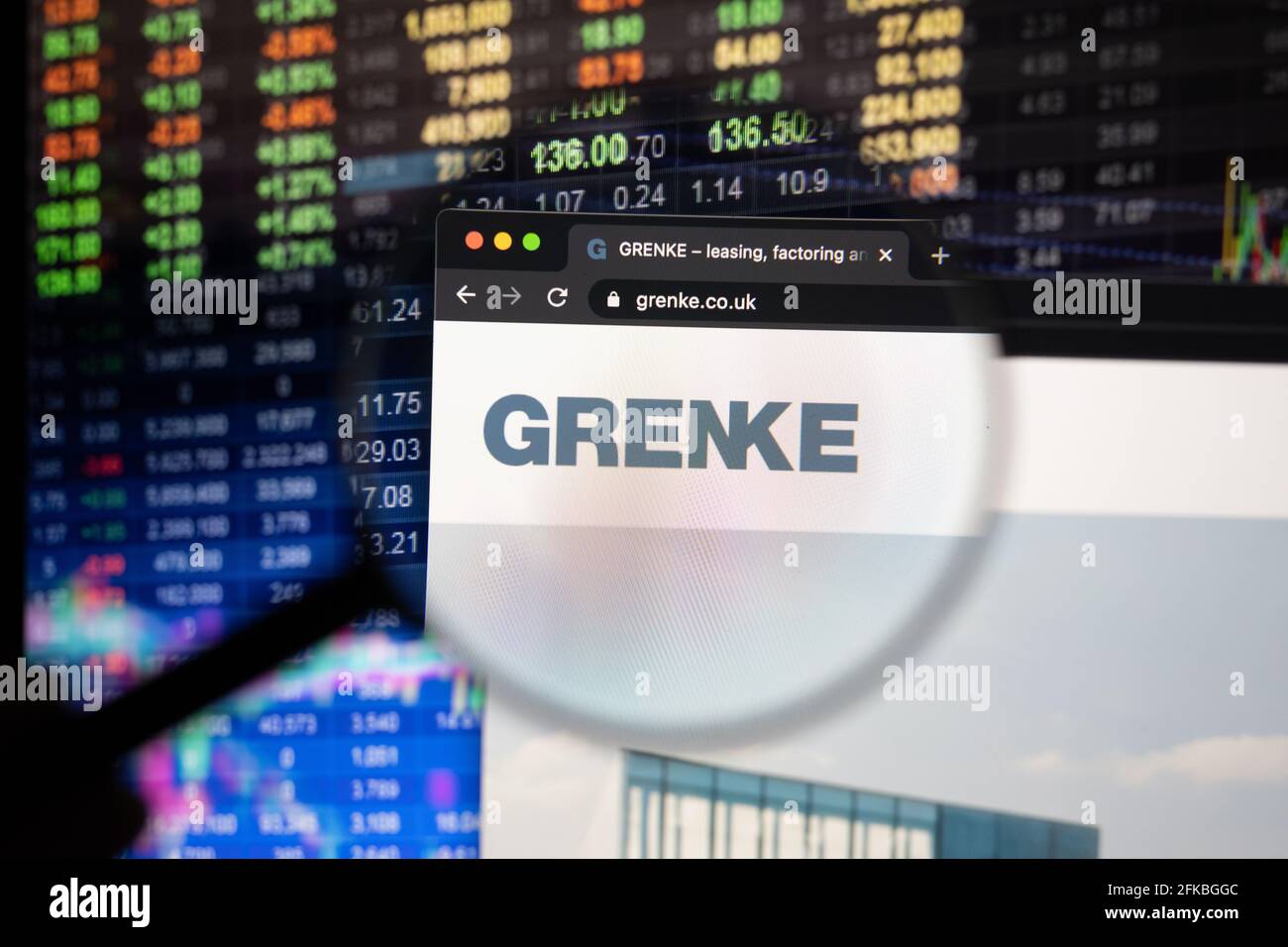 Grenke company logo on a website with blurry stock market developments ...