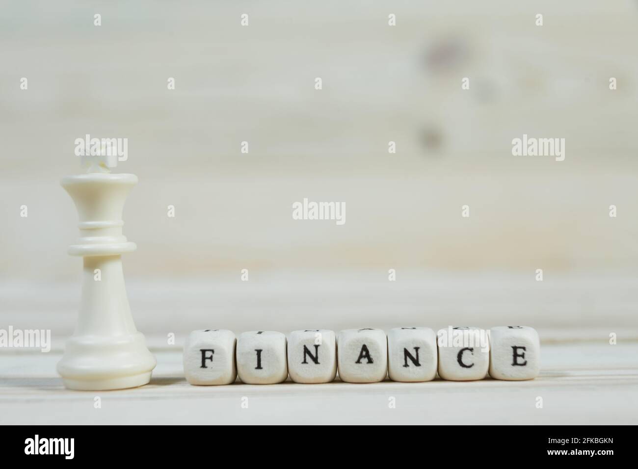 The figure of the king of chess and the word finance on wooden cubes ...