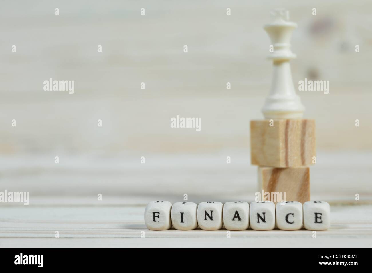 The figure of the king of chess and the word finance on wooden cubes ...
