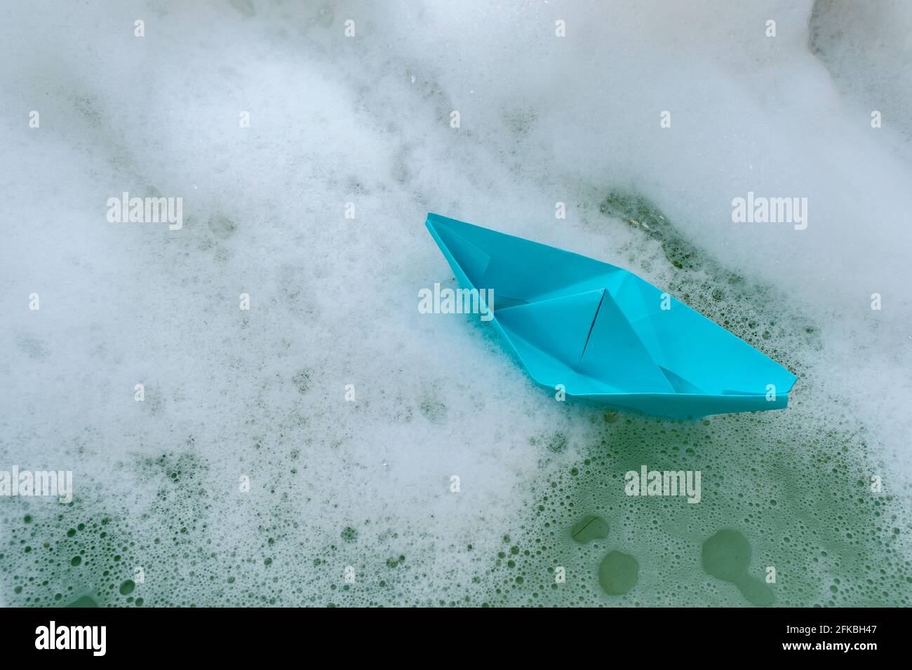 Origami in the form of a paper boat in soapy water in a bath Stock ...