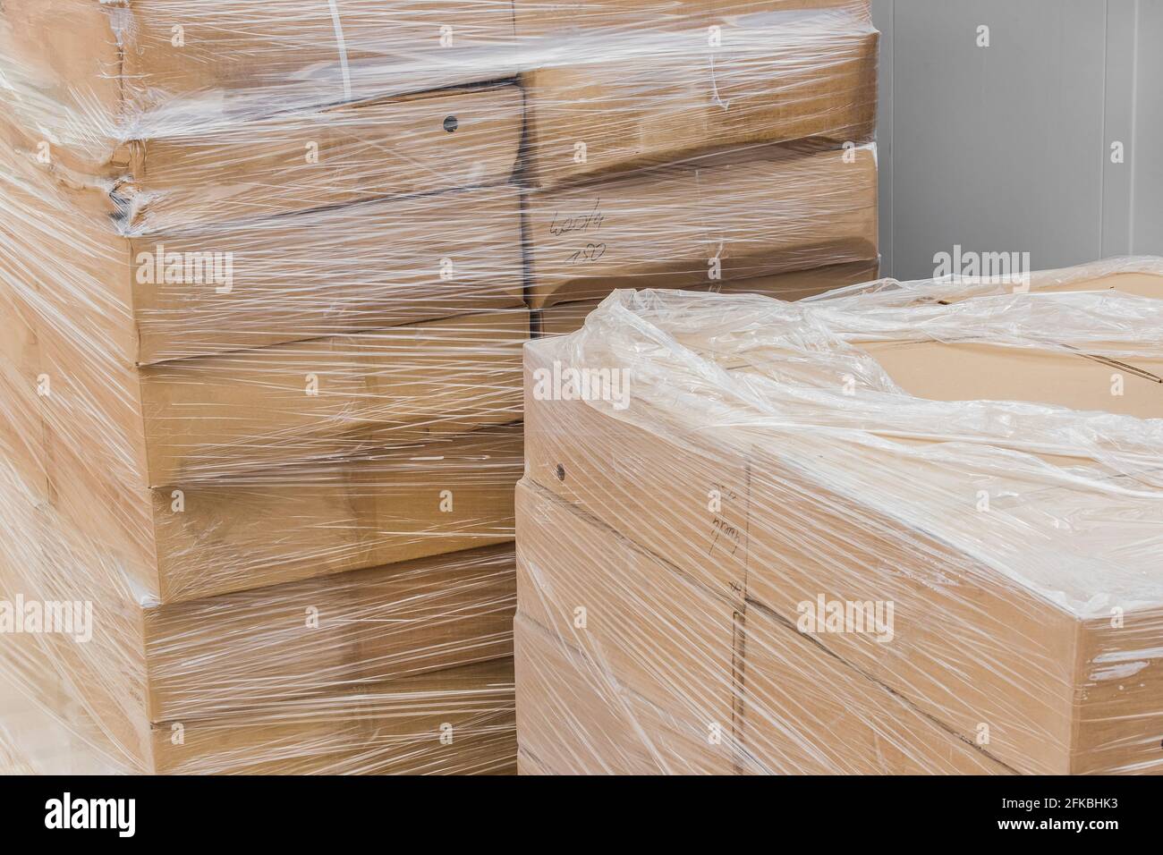 A bunch of cardboard boxes with building materials packed in plastic ...