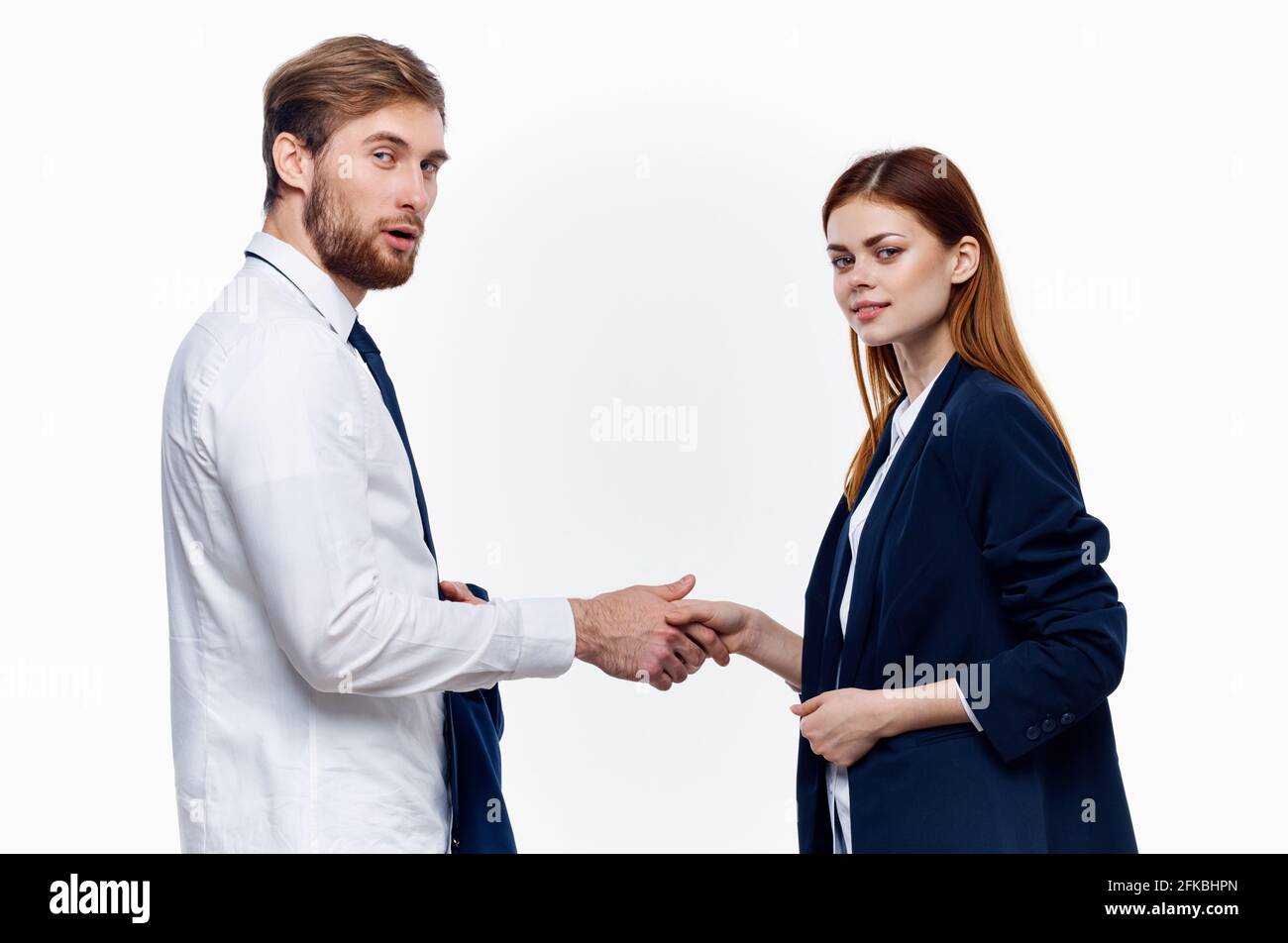 work colleagues shake hands communication contract light background ...