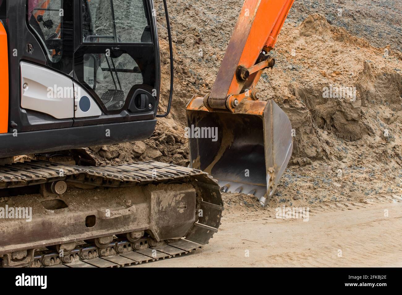 Crawler industrial machine excavator with a bucket on the background of ...