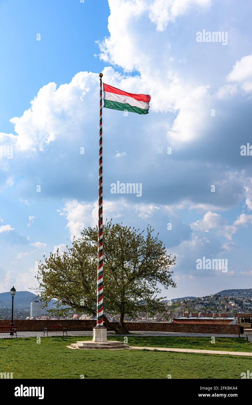 A Hungarian flag on a flagpole on a windy day in the Buda ...