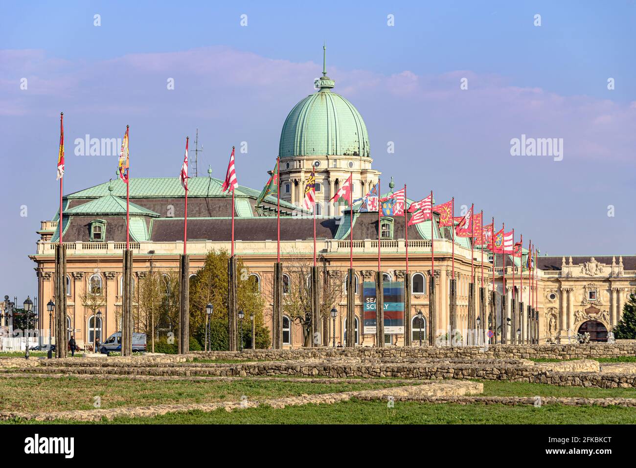 The Royal Palace in the Buda Castle District with historical flags ...