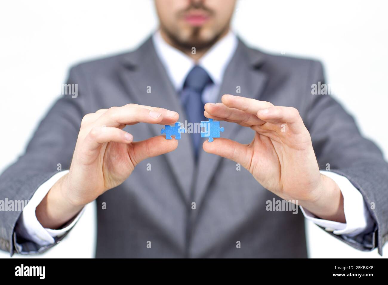 Hands fingers businessman team work holding and join pieces two jigsaw ...