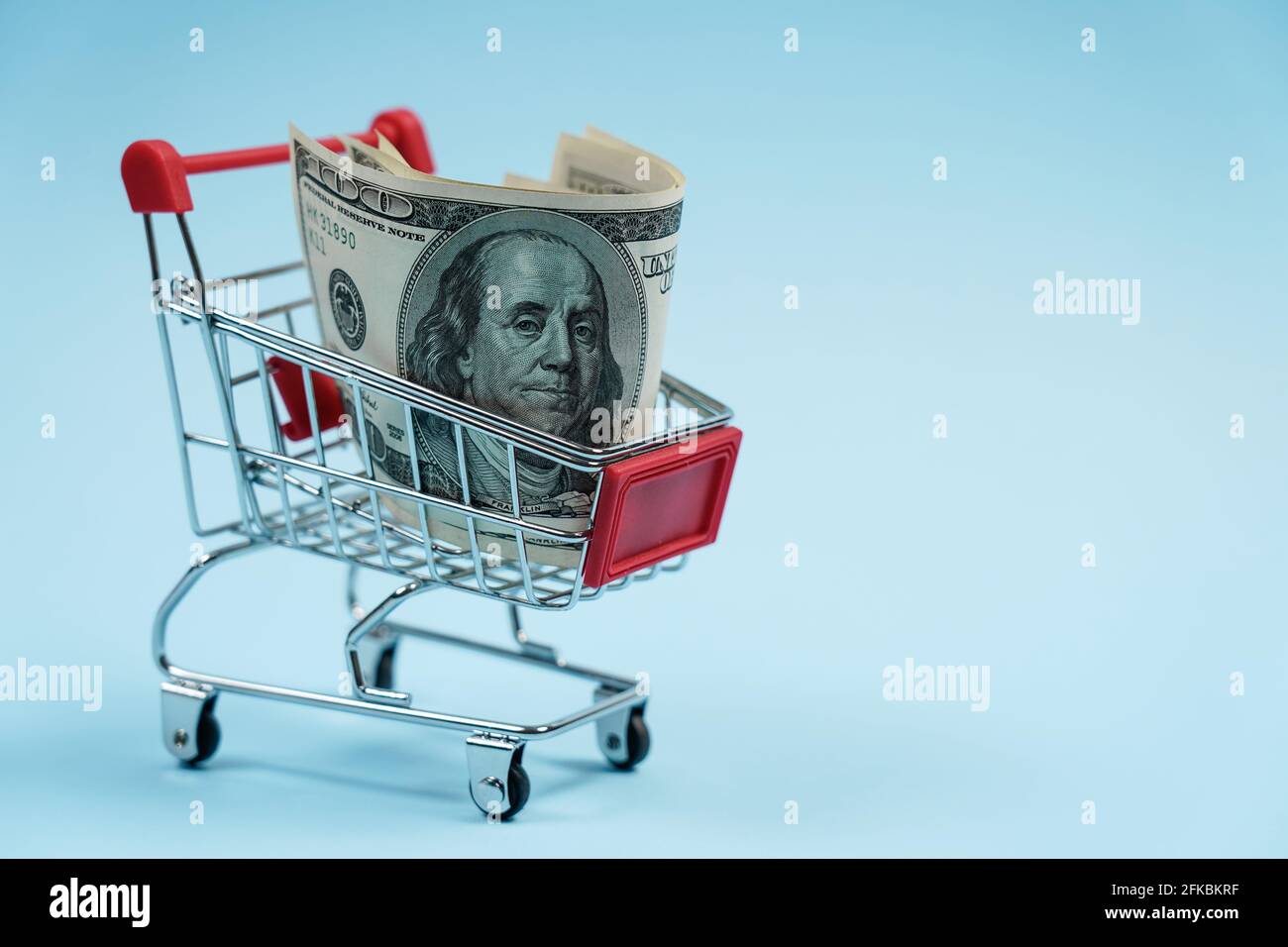 US dollars in shopping cart over blu background ,Dollar bill collect on ...
