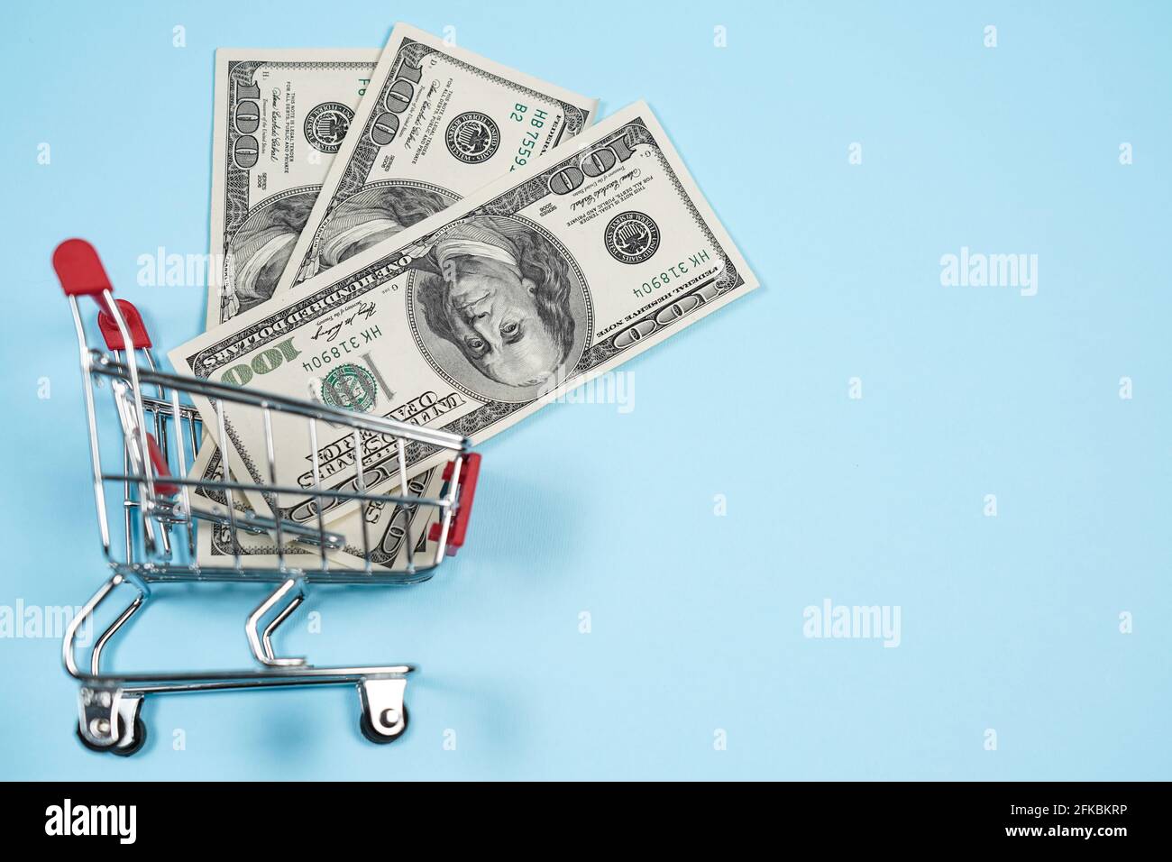 US dollars in shopping cart over blu background ,Dollar bill collect on ...