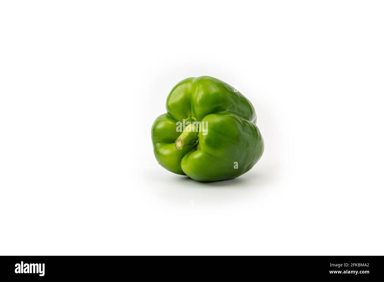 Single whole green pepper on a white background Stock Photo - Alamy