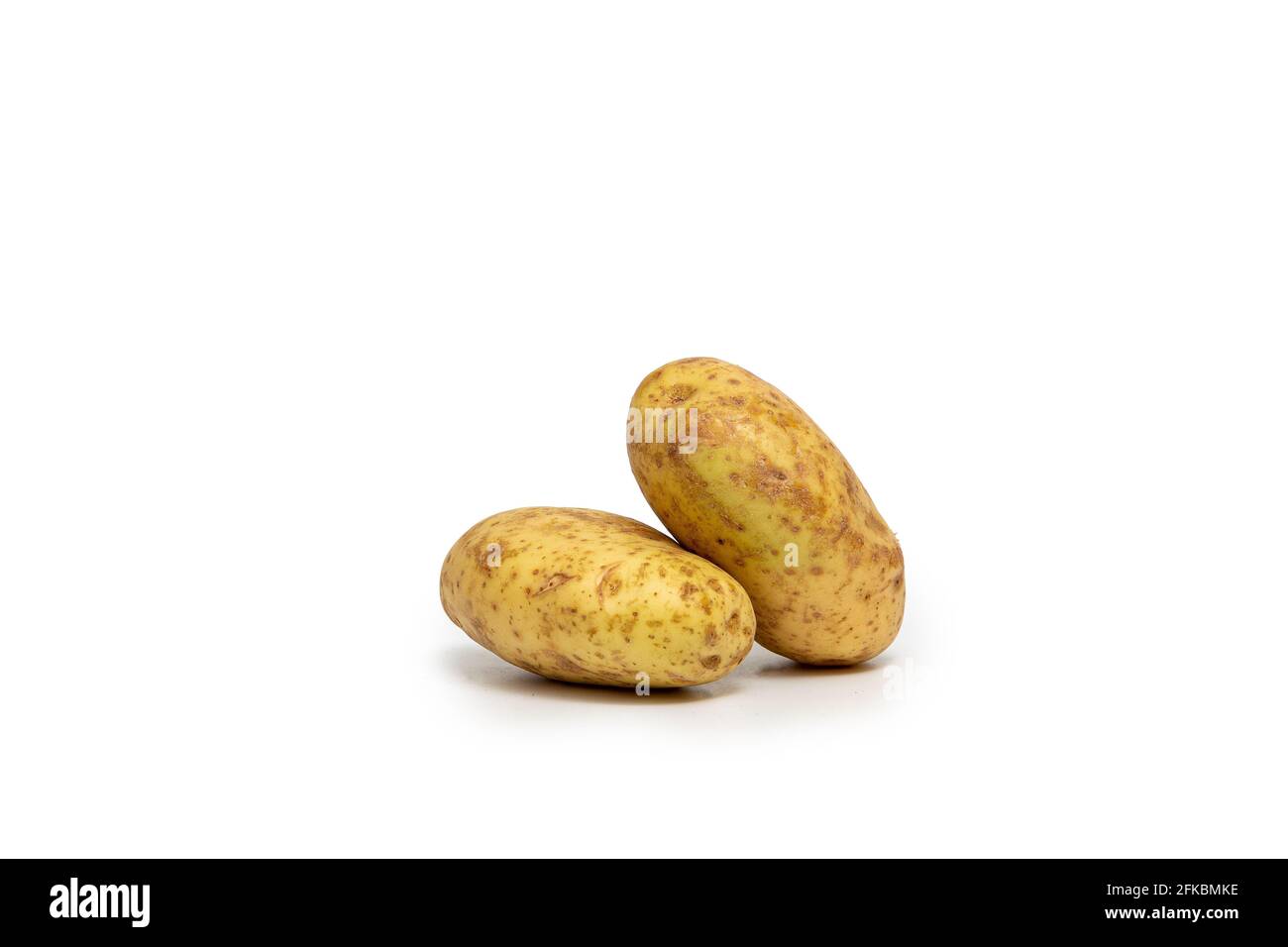 Two washed white potatoes on a white background Stock Photo - Alamy