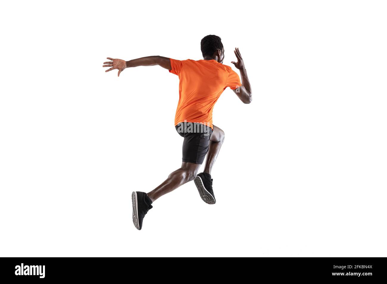Sportive African-American man, athlete running isolated over white ...