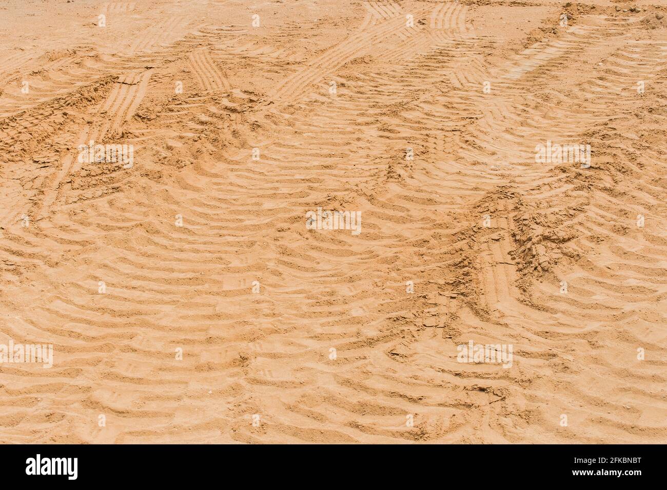 Industrial vehicle tracks on the sand road wheel tire trail at a ...