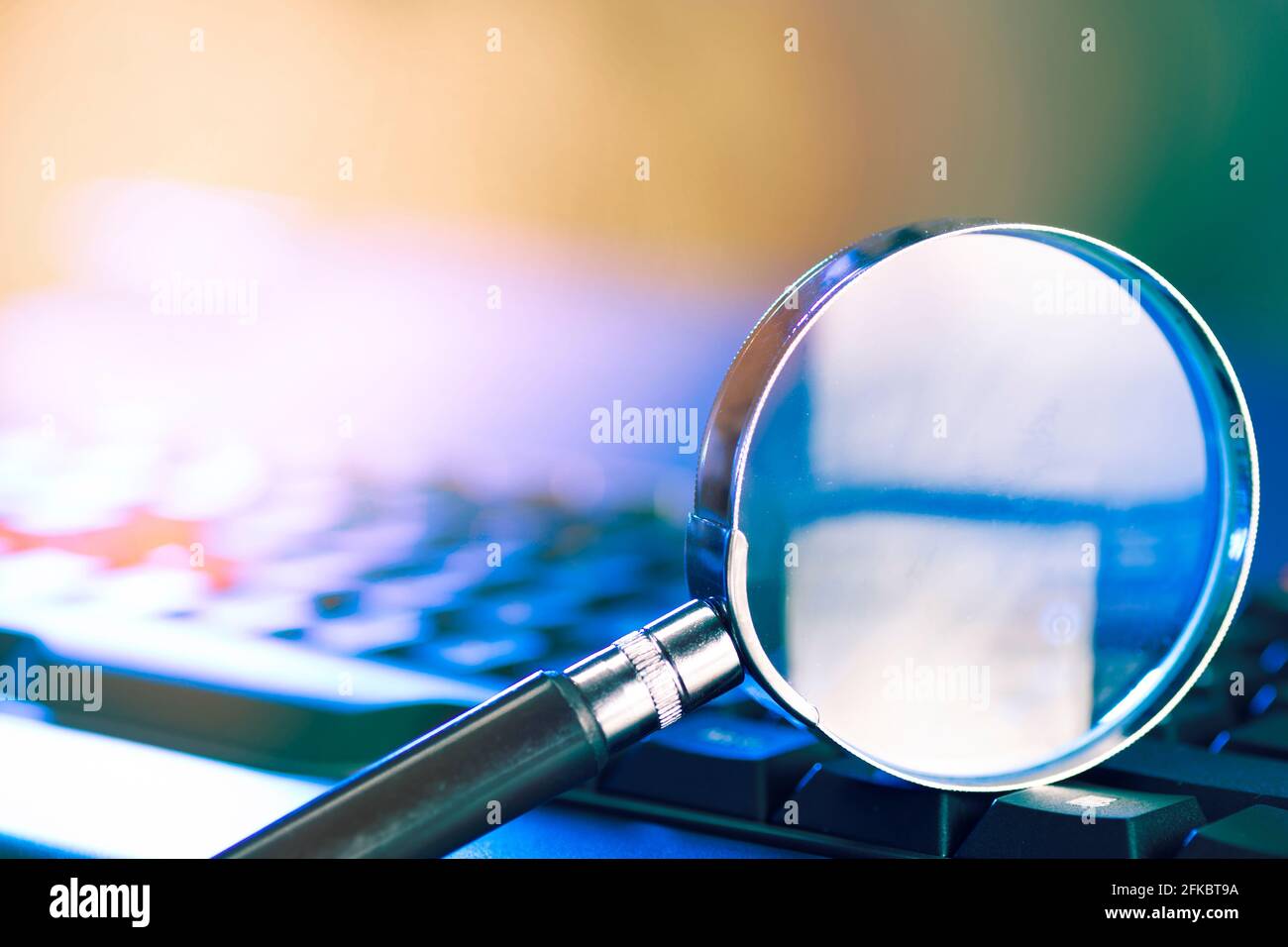Magnifying glass on the keys of a black computer keyboard Stock Photo ...
