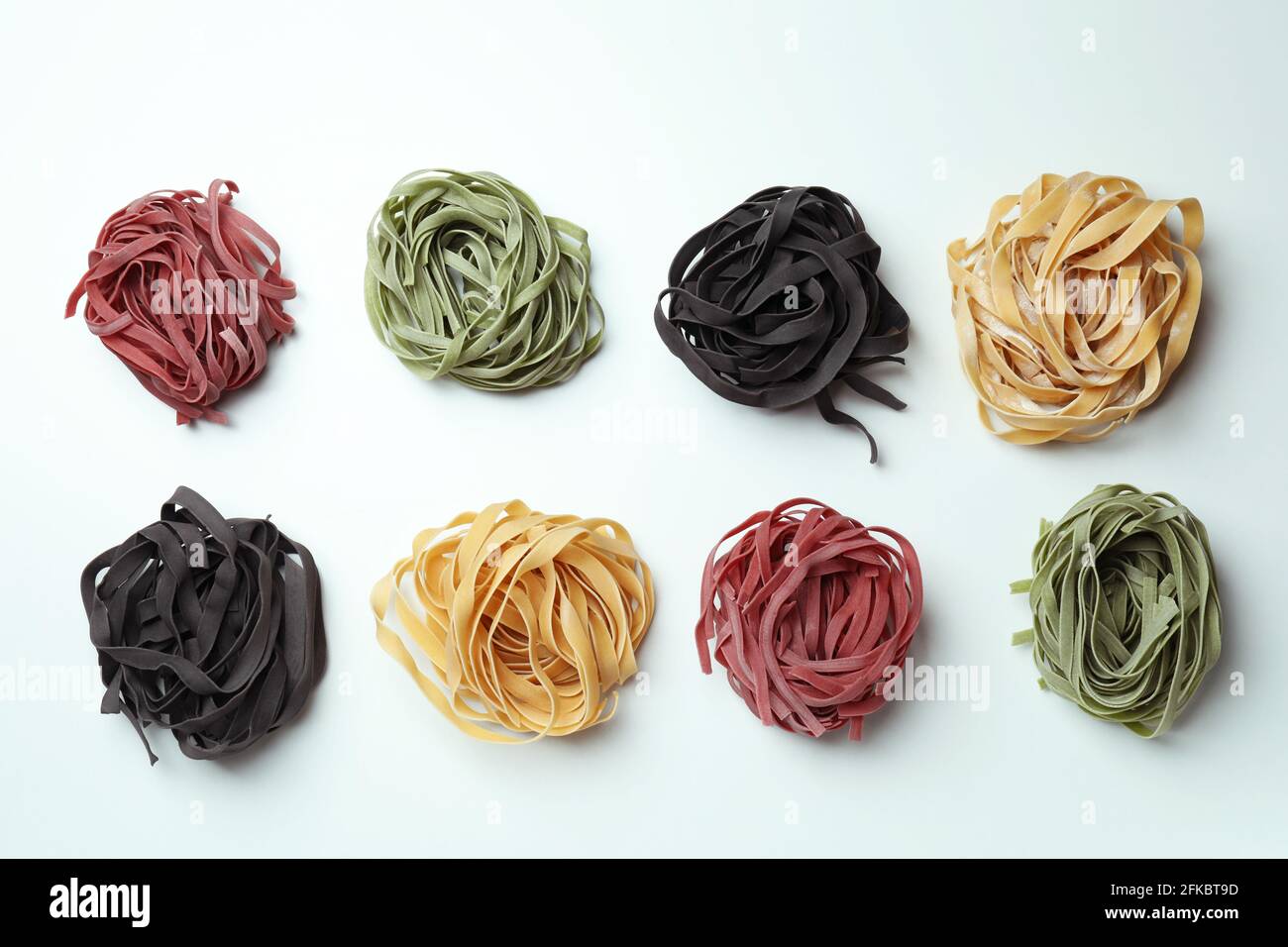 Different uncooked multicolor pasta on white background Stock Photo - Alamy