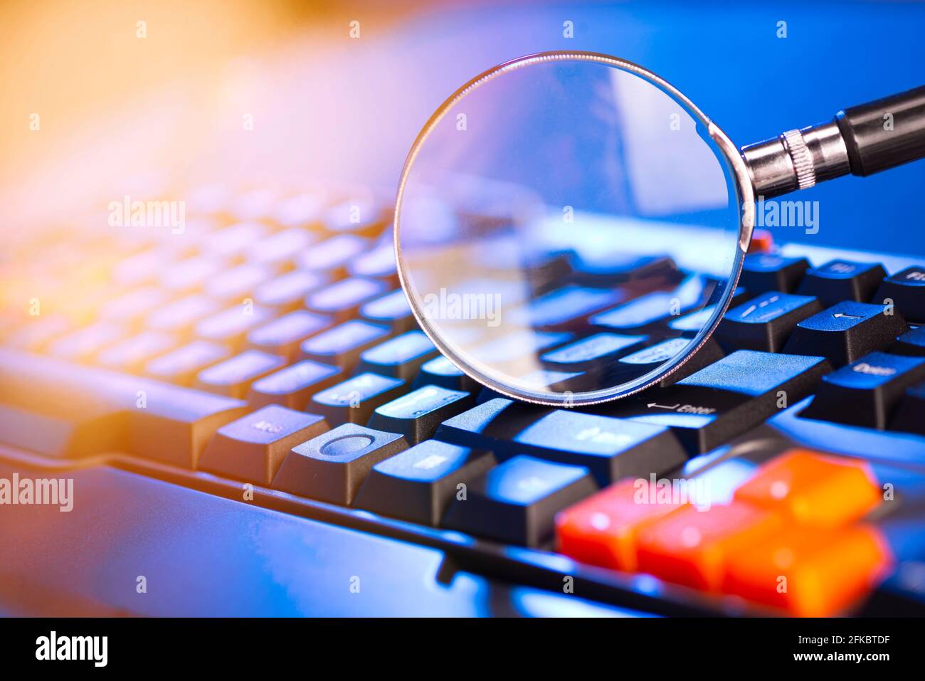 Magnifying glass on the keys of a black computer keyboard Stock Photo ...