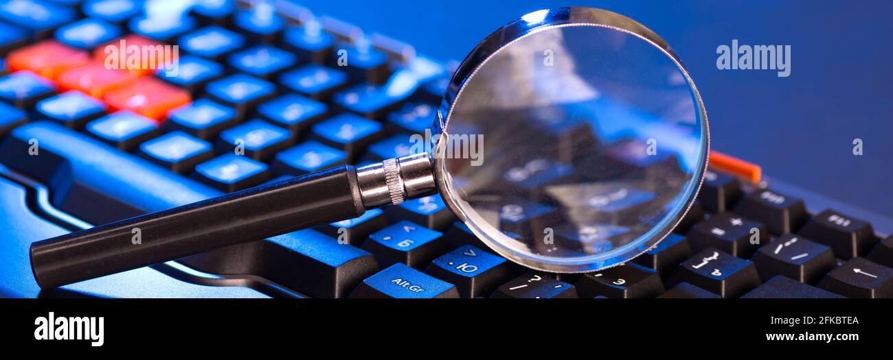 Magnifying glass on the keys of a black computer keyboard Stock Photo ...