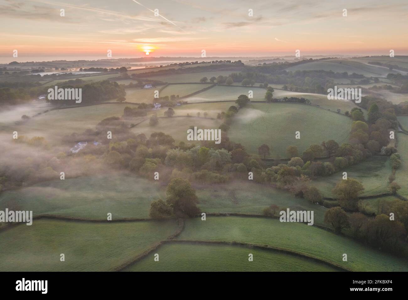 Misty spring sunrise over rolling countryside, South Tawton, Devon ...