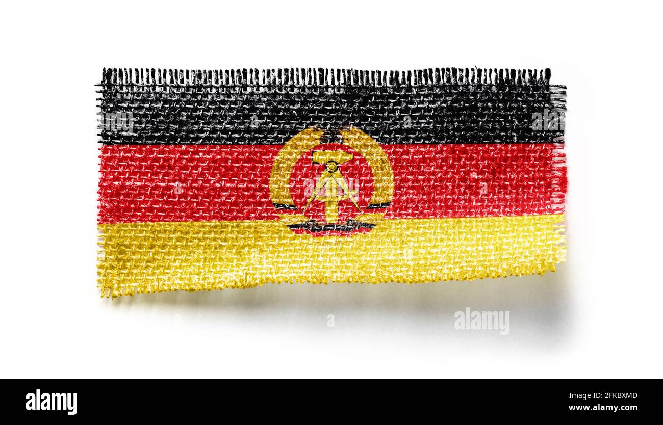 GDR flag on a piece of cloth on a white background Stock Photo - Alamy