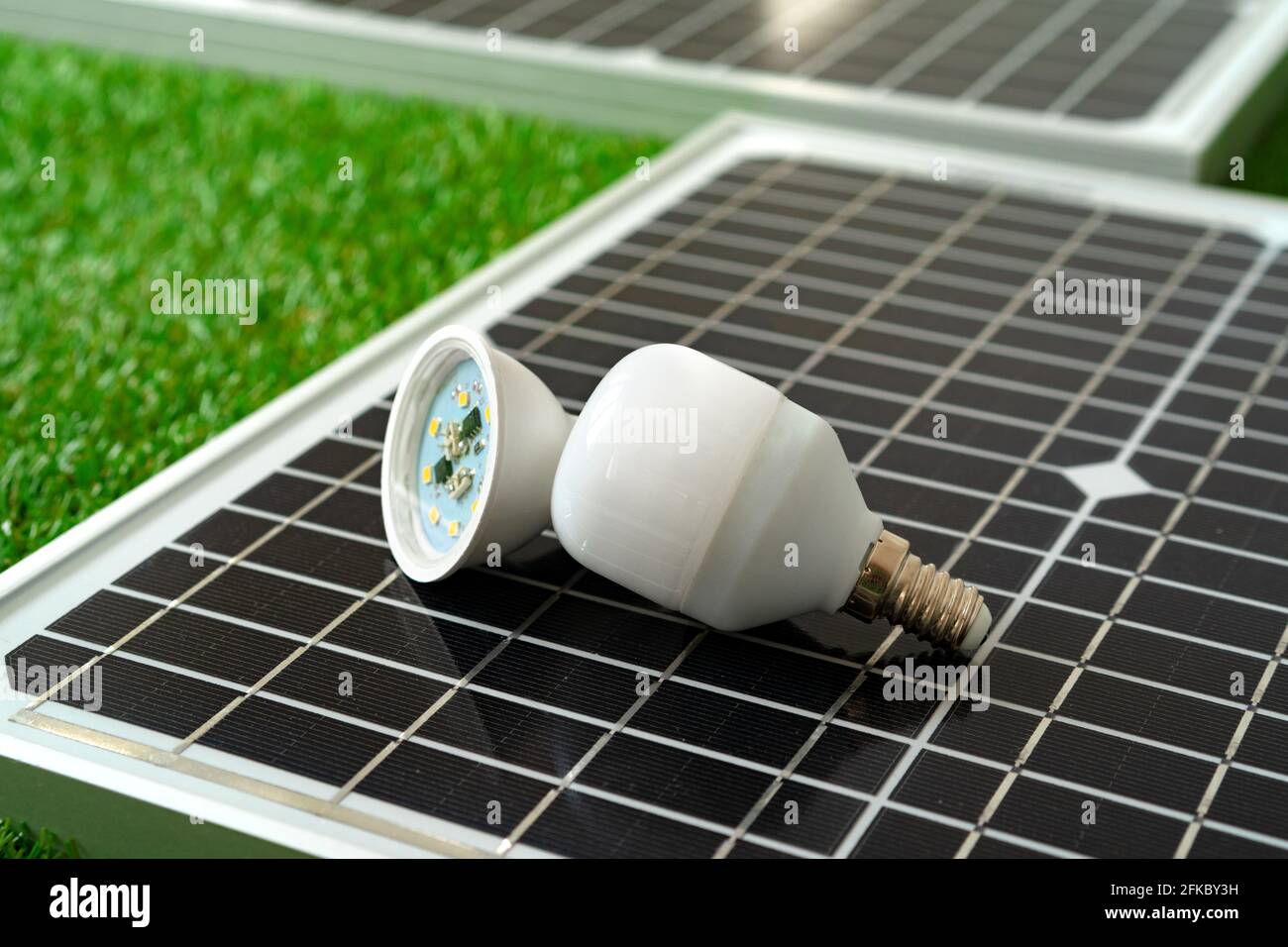Solar energy panel and light bulb, green energy Stock Photo - Alamy