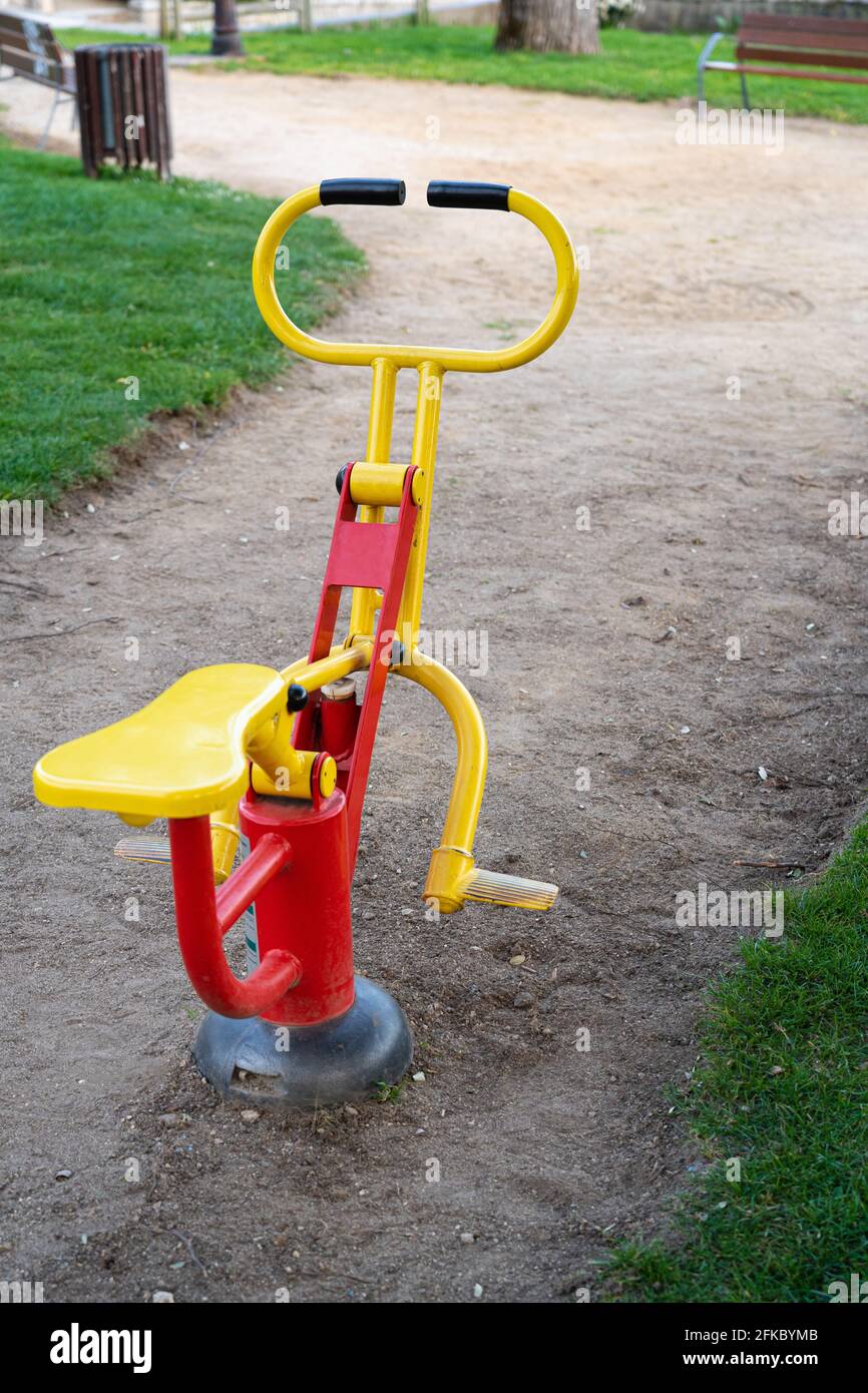 Red and yellow gym machine in an outdoor gym park Stock Photo - Alamy