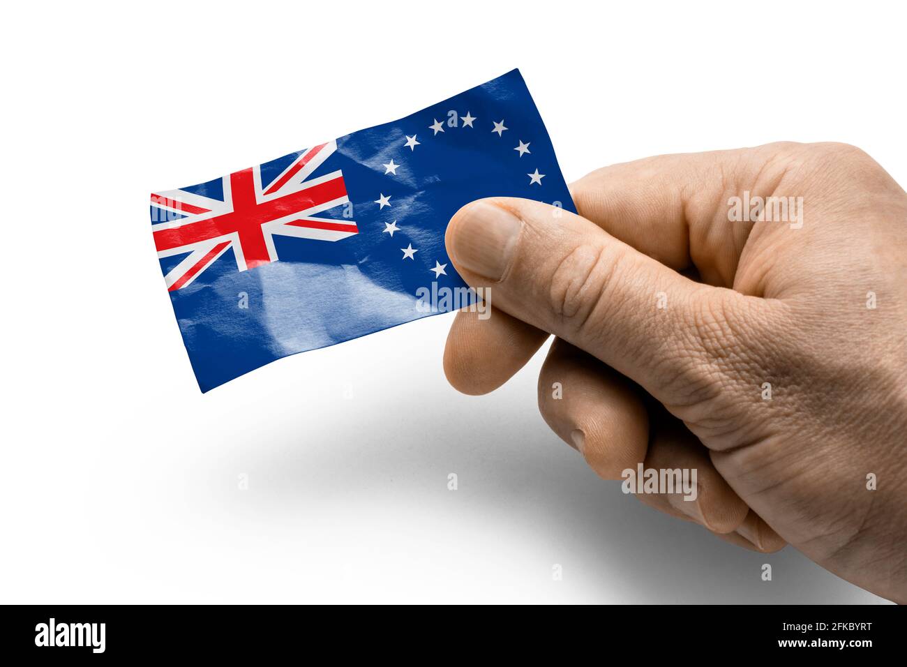 Hand holding a card with a national flag the Cook Islands Stock Photo ...