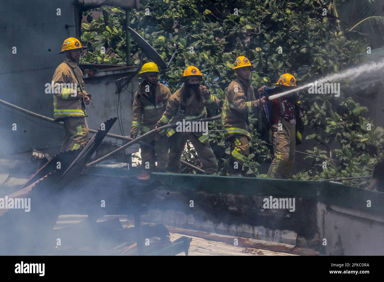 Manila, Philippines. 30th Apr, 2021. Firefighters try to put out a fire ...
