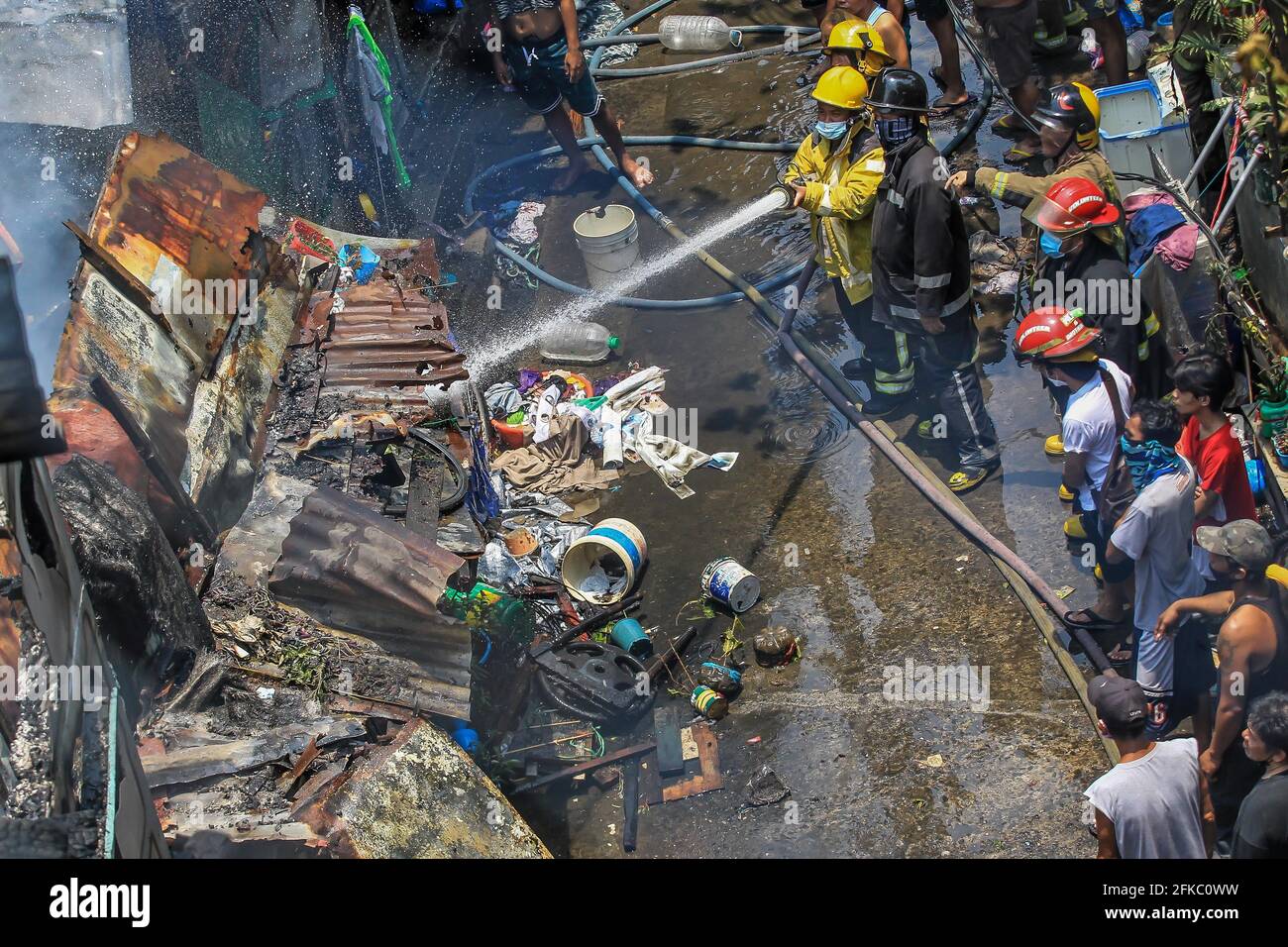 Manila, Philippines. 30th Apr, 2021. Firefighters try to put out a fire ...