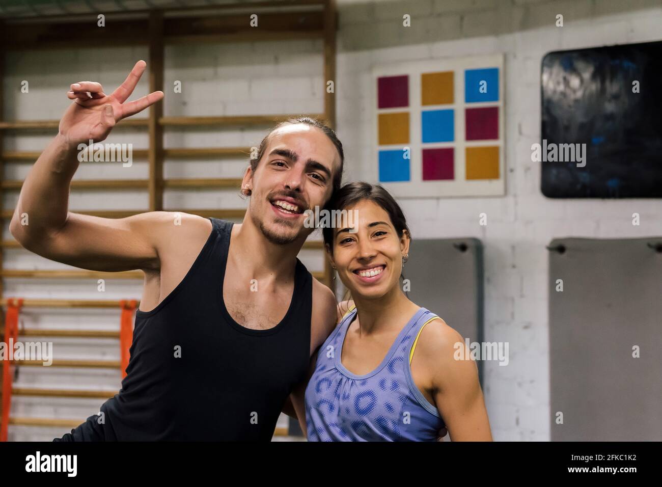 portrait of a happy sports couple at the gym, active and sporty ...