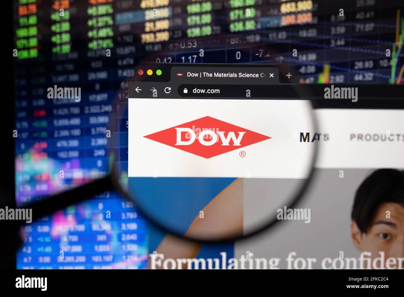 Dow company logo on a website with blurry stock market developments in ...