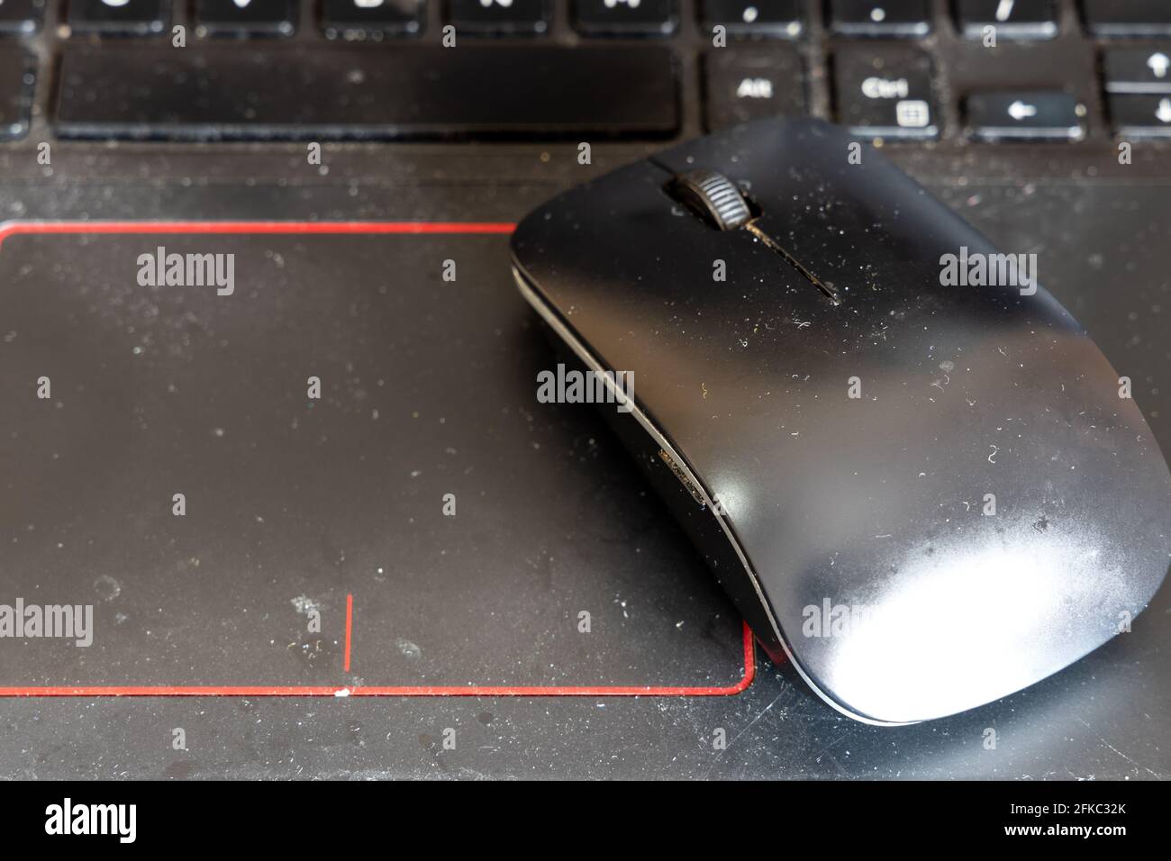 Close-up on dirty and unhygienic computer laptop mouse and keyboard ...