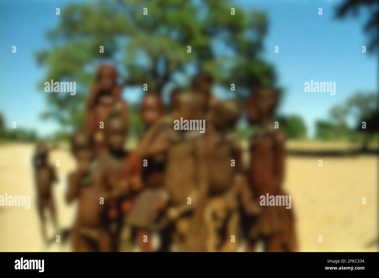 Defocused blurred foto of group kids from native people himba tribe in ...