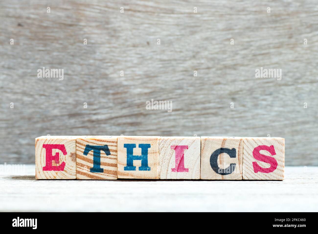 Alphabet letter block in word ethics on wood background Stock Photo - Alamy