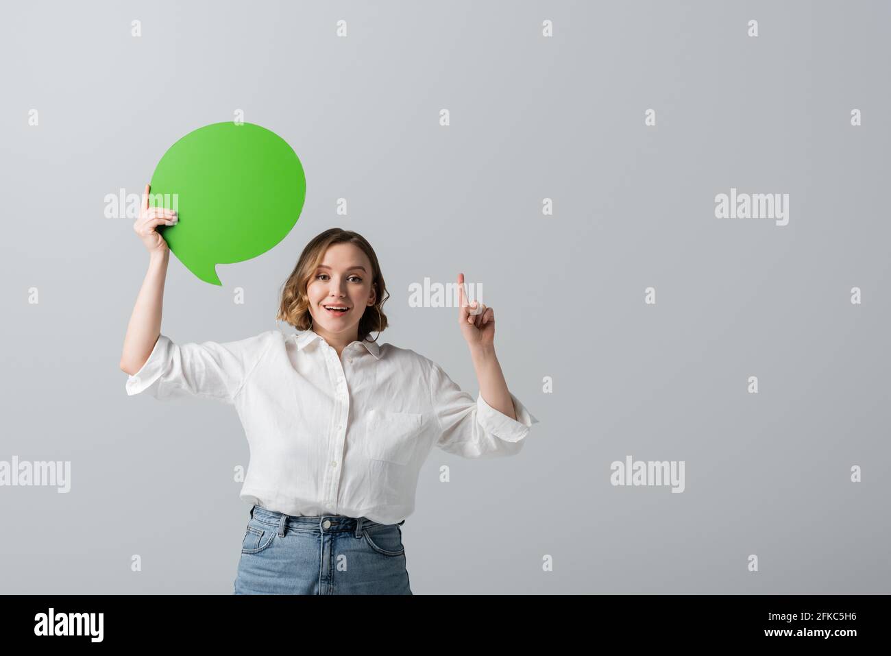 happy overweight woman in white shirt holding green speech bubble and ...