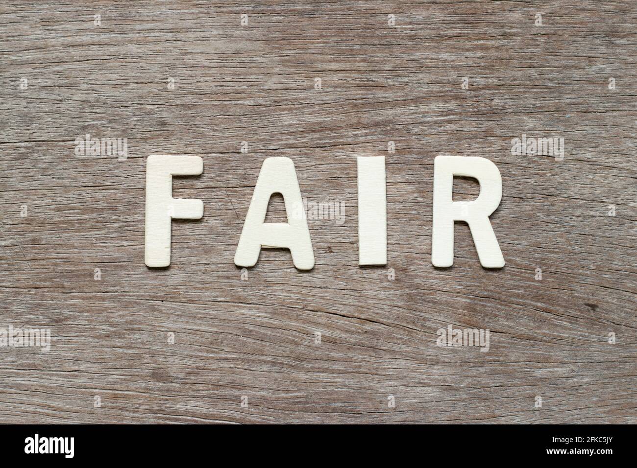 Alphabet letter in word fair on wood background Stock Photo - Alamy