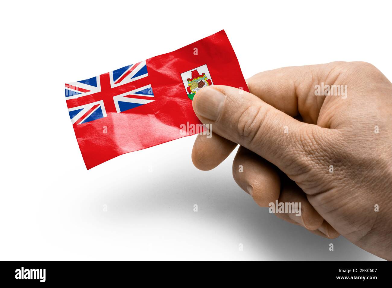 Hand holding a card with a national flag the Bermuda Stock Photo - Alamy