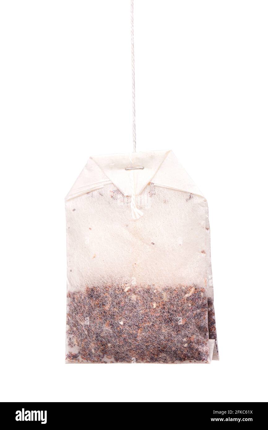 Herbal tea in paper bag. Teabag hanging against white background Stock ...