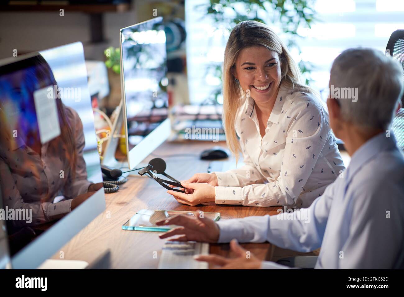 Young joyful woman being mentored by female senior partner in the ...