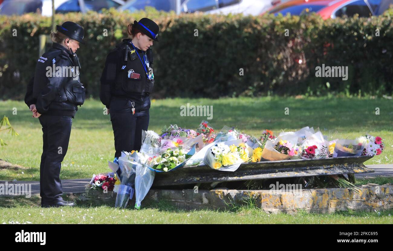 Police Community Support Officers look at flowers left in memory of ...