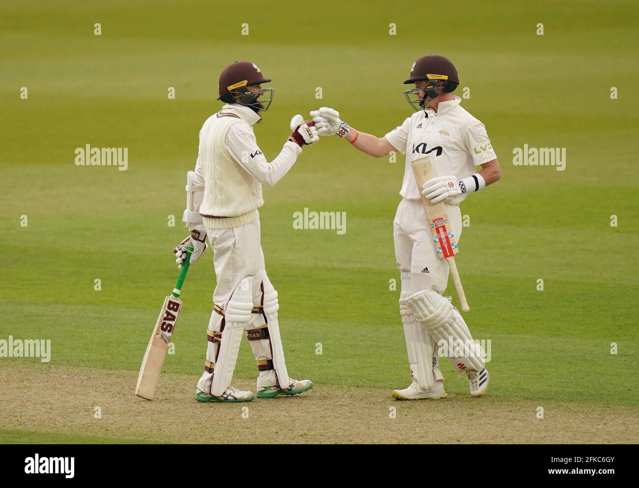 Surrey's Hashim Amla (left) congratulates Ollie Pope (right) on ...