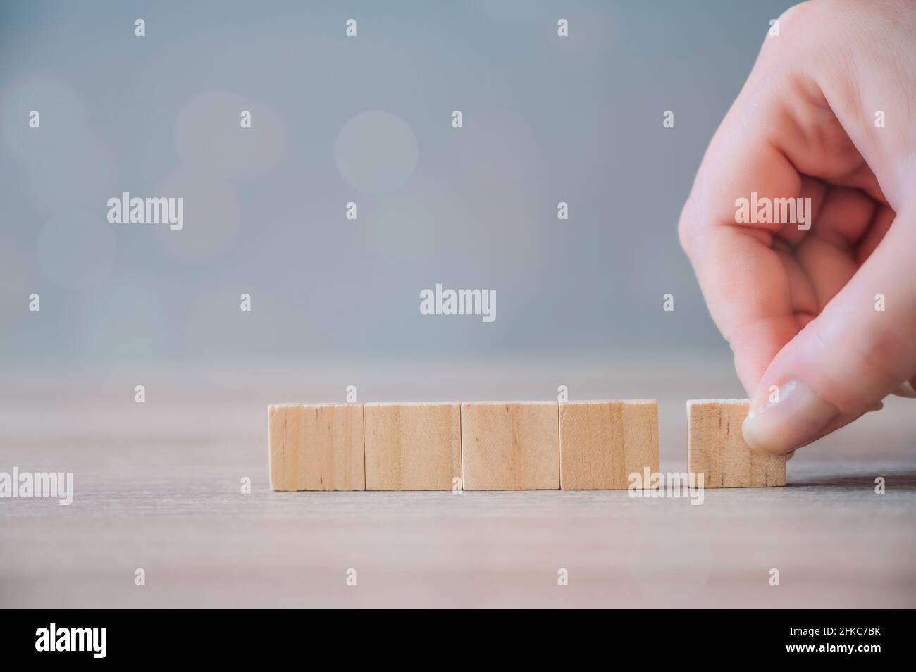 Hand arranging wood blocks. Business growth, success, process concept ...