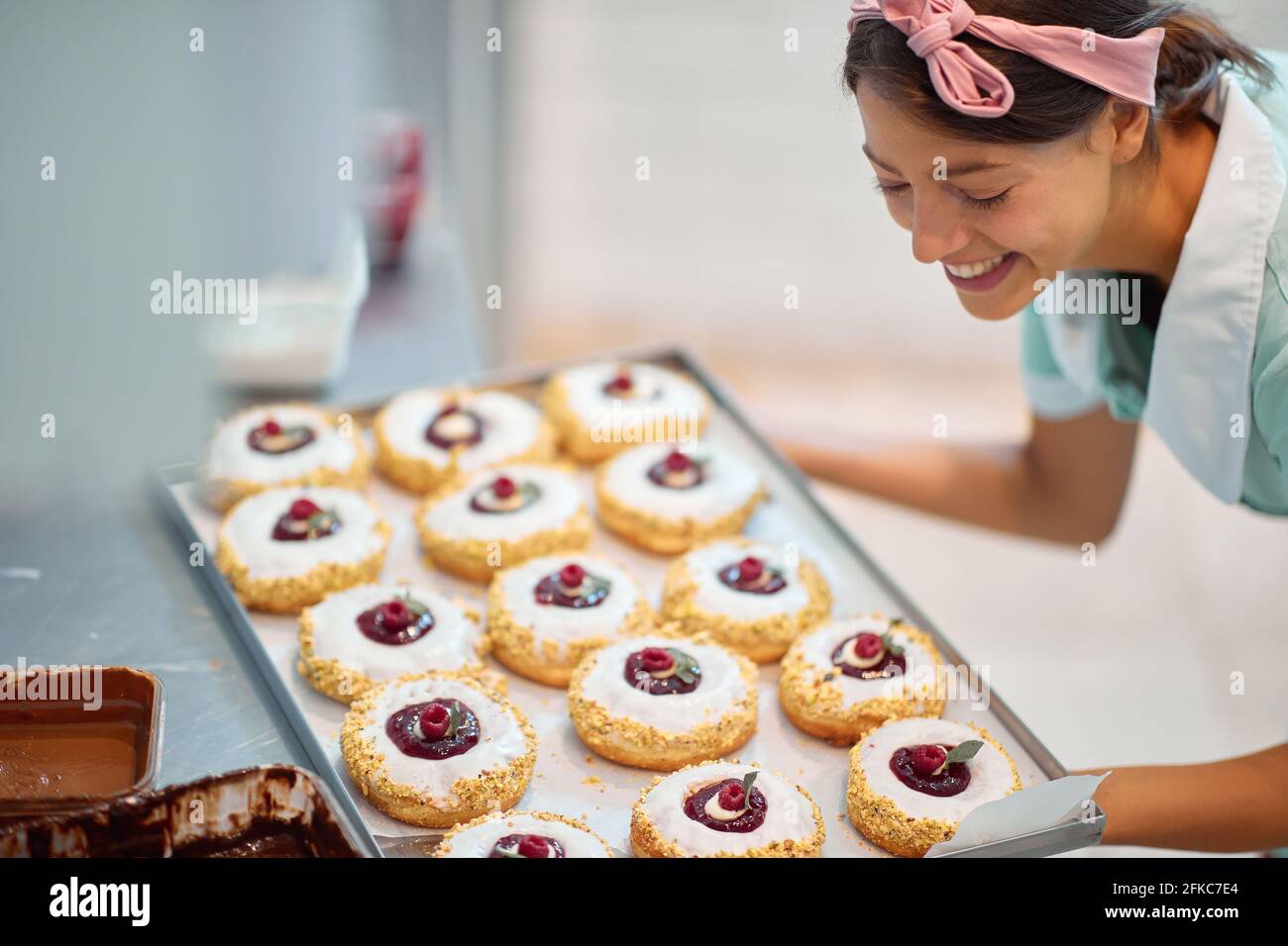 A young small business female owner is satisfied with her handmade ...