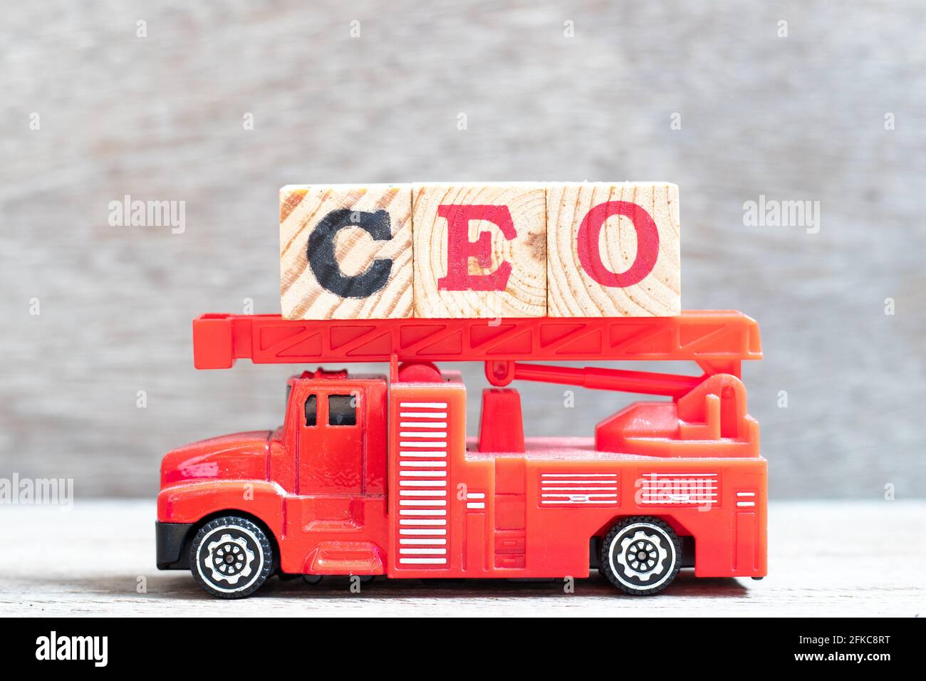 Red fire truck hold letter block in word CEO (abbreviation of Chief ...
