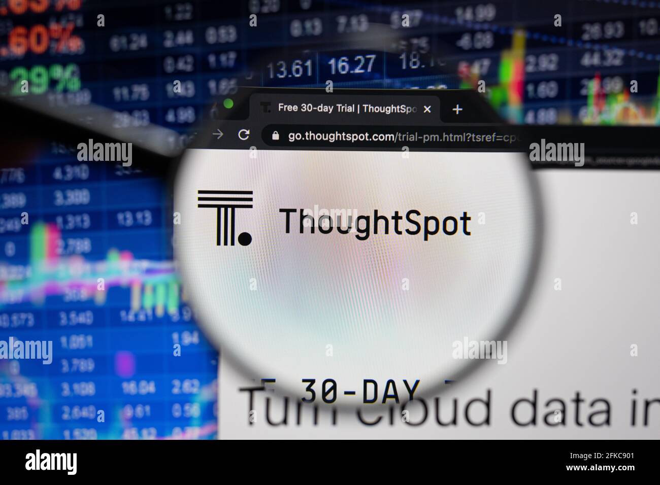 ThoughtSpot company logo on a website with blurry stock market ...