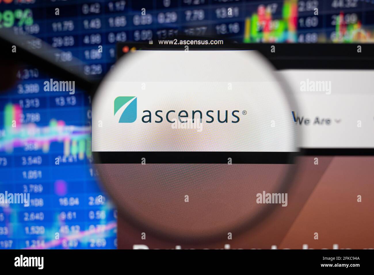 Ascensus company logo on a website with blurry stock market developments in the background, seen ...