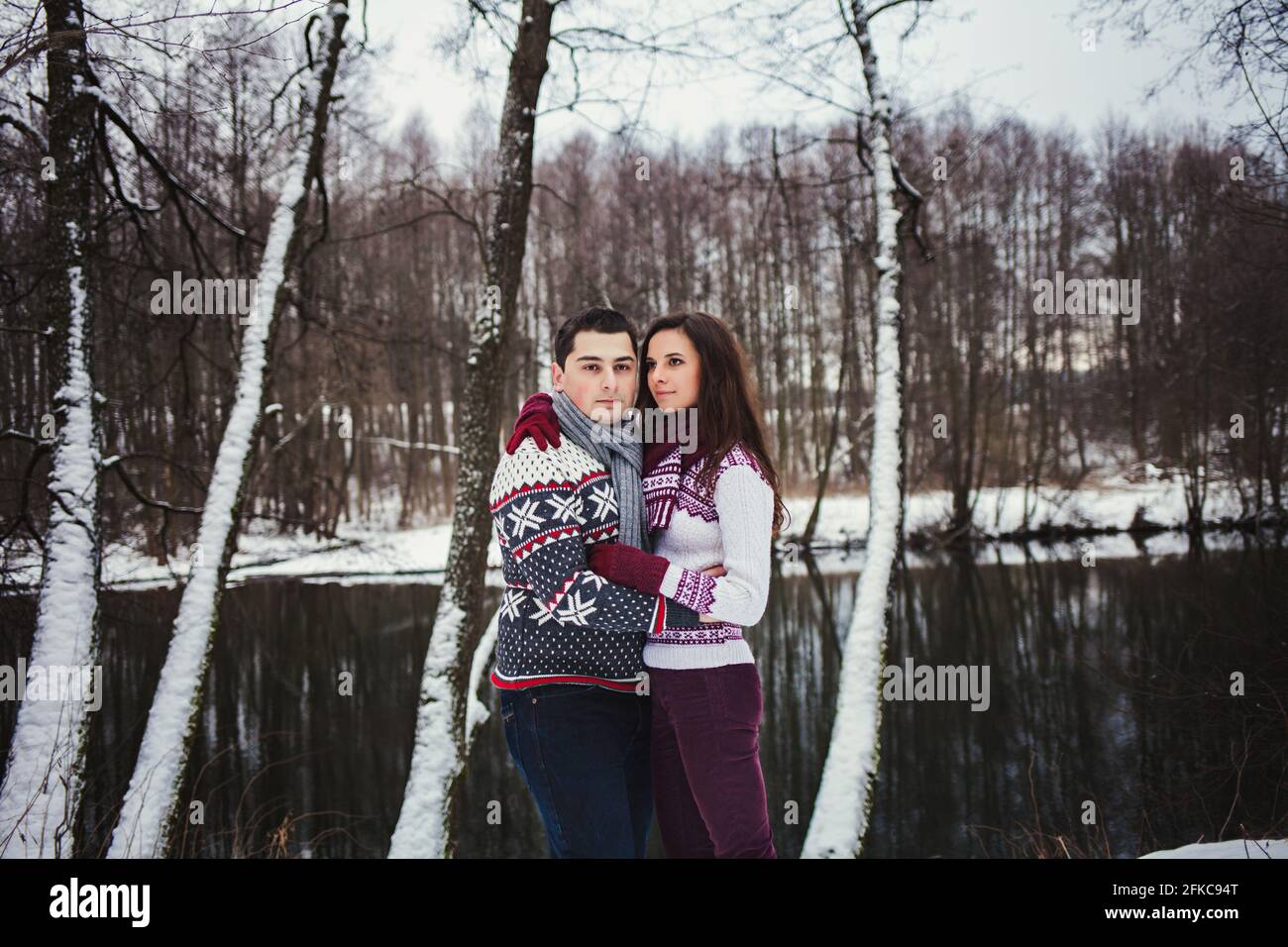 Romantic couple in a sweater hugging in nature Stock Photo - Alamy