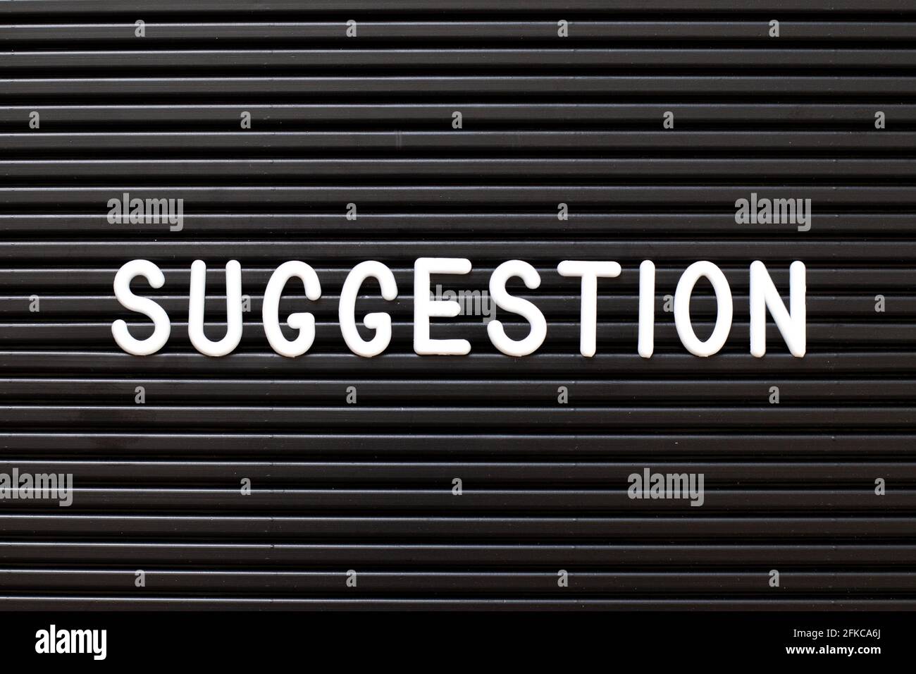 Black color felt letter board with white alphabet in word suggestion ...