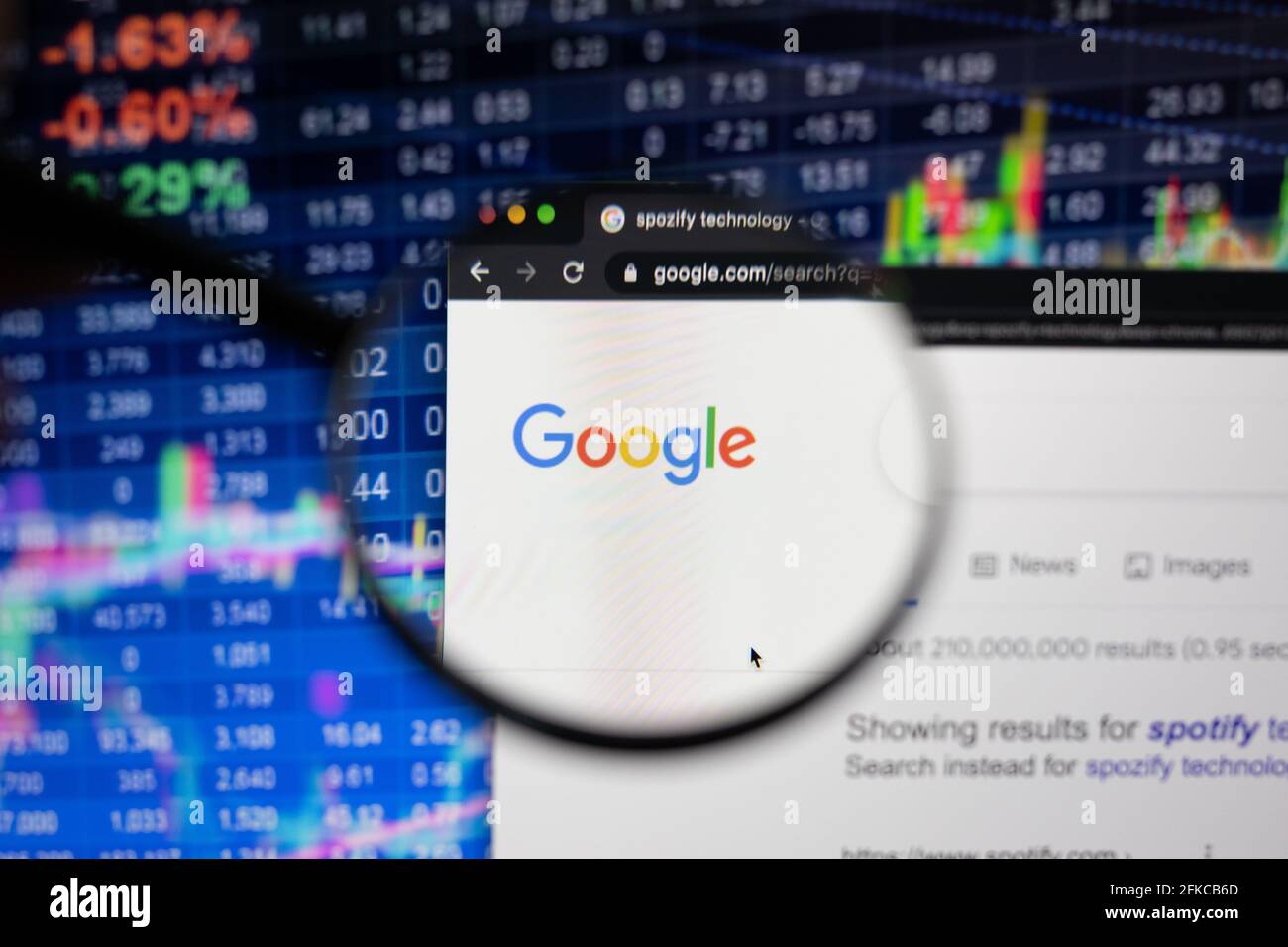 Google company logo on a website with blurry stock market developments in the background, seen ...