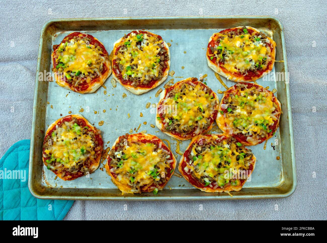 Eight individual size mini home made pizzas are cooling just a little ...