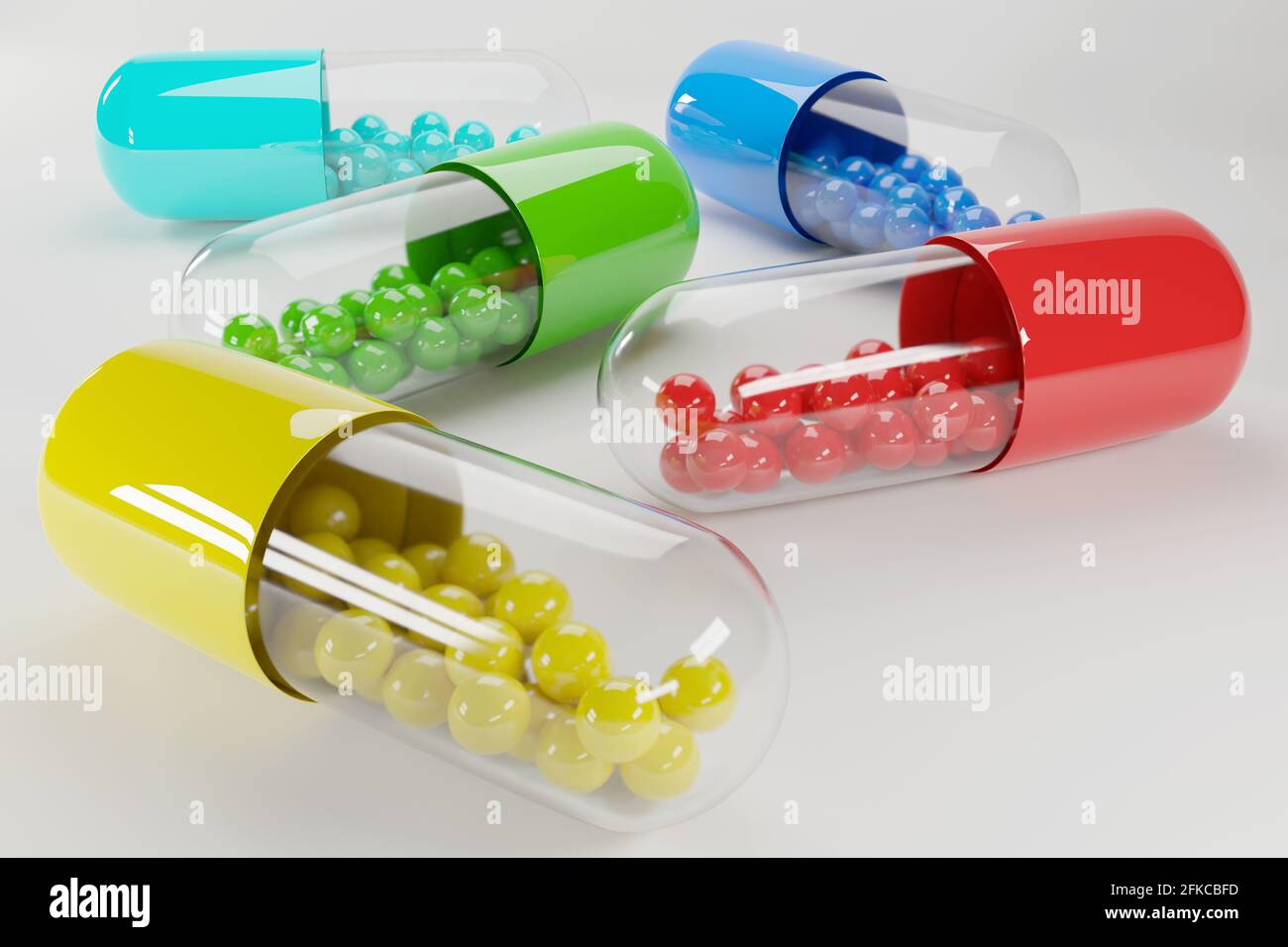 Group of transparent colored medication capsules or pills with content ...