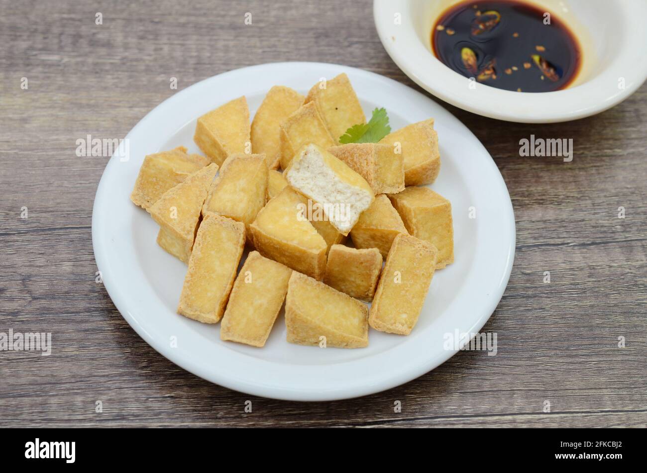 Eating of fried tofu diced with soy sauce Stock Photo - Alamy